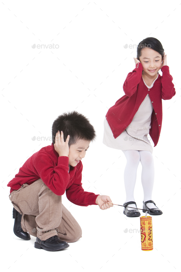 Little boy and little girl igniting firecracker together Stock Photo by ...