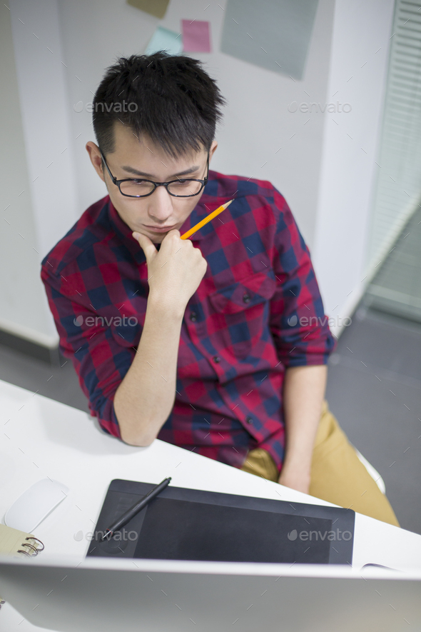Illustrator working in office Stock Photo by bluejeanimages | PhotoDune