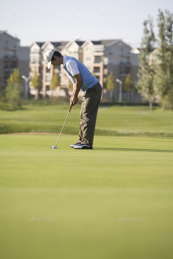 Golfer putting on the Green Stock Photo by bluejeanimages | PhotoDune