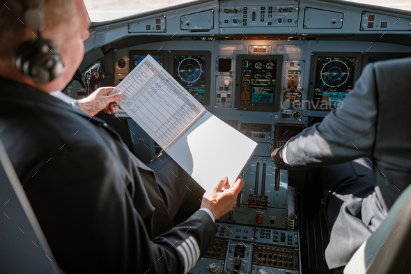 Aircraft pilot studying documents before the flight in cockpit Stock ...