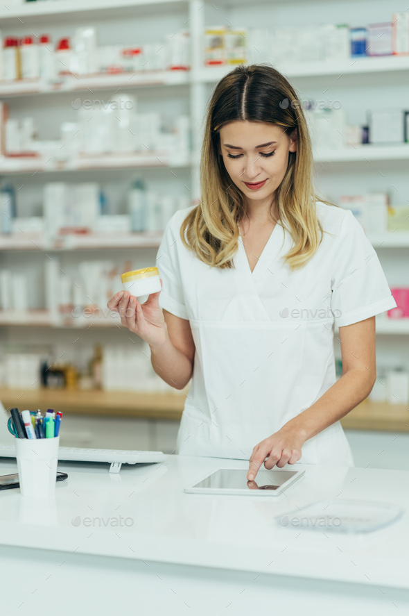 Portrait of a beautiful female pharmacist working in a pharmacy Stock ...