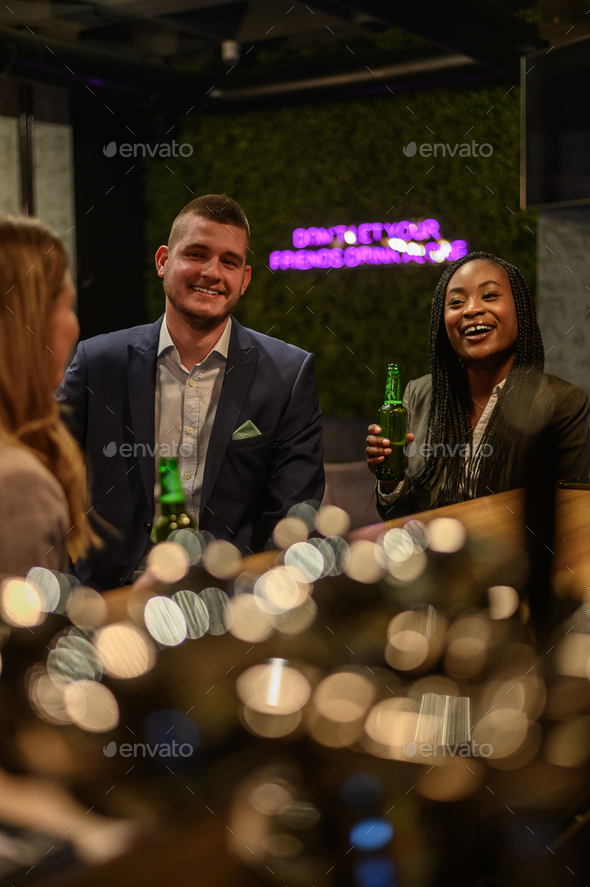 Cheerful colleagues drinking beer in the bar together after work Stock ...