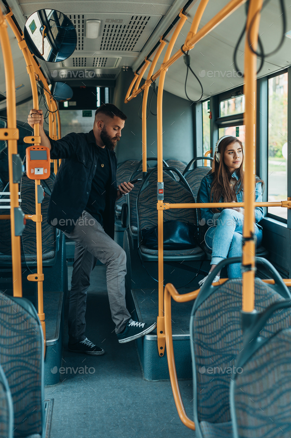 Passengers using smartphones while riding the bus Stock Photo by ...