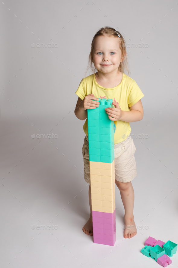 Adorable little kid playing with colorful blocks. Stock Photo by ...
