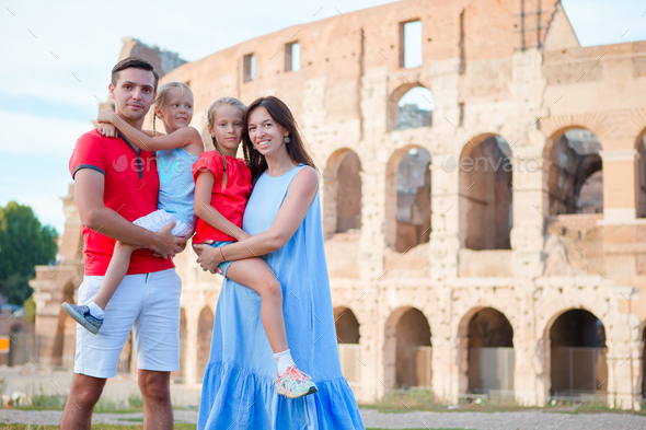 Happy family in Rome over Coliseum background. Italian european ...