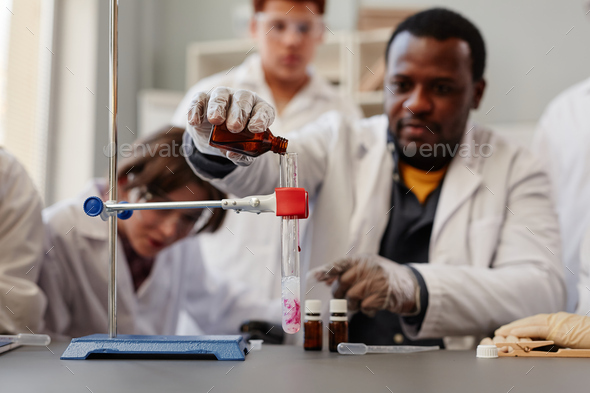 Teacher Demonstrating Experiment in Science Lab Stock Photo by ...