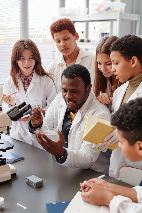 Science Teacher Demonstrating Experiment to Kids Stock Photo by ...