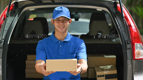 Delivery man portrait shot with working box service express. Stock ...