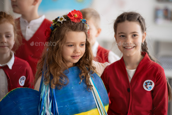 Schoolchildren welcoming new Ukrainian classmate, concept of enrolling ...