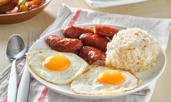 filipino silog breakfast with garlic fried rice, longsilog, and two ...