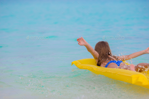 Adorable little girl on air inflatable mattress in the sea Stock Photo ...