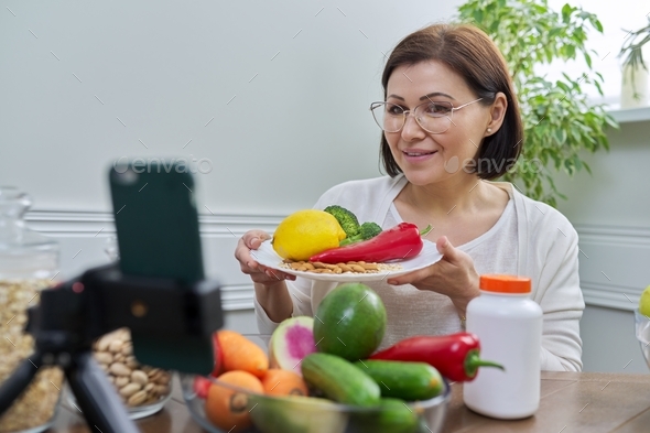 Woman recording video stream about healthy eating, vitamins ...