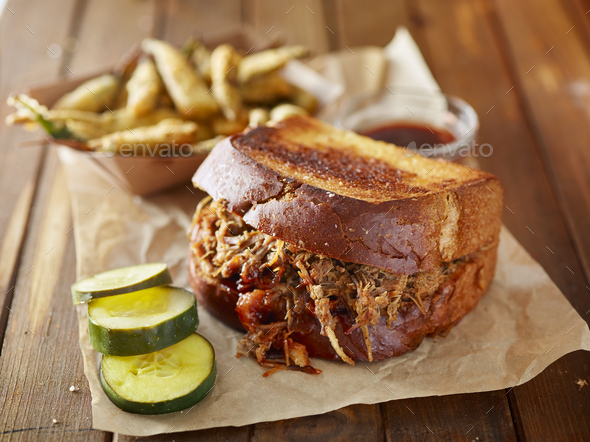 barbecue pulled pork sandwich with fried okra Stock Photo by joshua_resnick