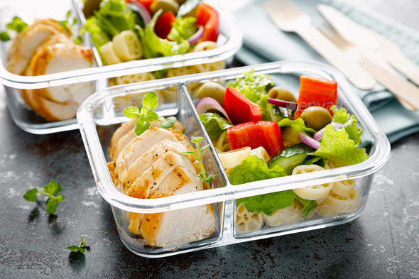 Lunch boxes with grilled chicken breast and pasta salad with fresh ...