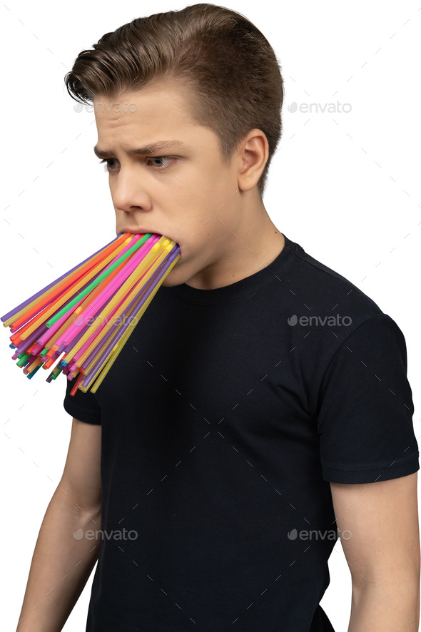 a young man biting into a bunch of colored straws Stock Photo by Icons8