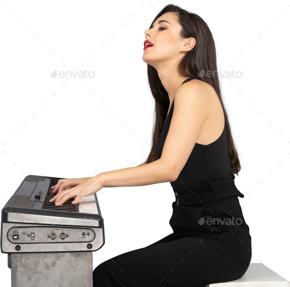 a woman sitting on a stool typing on a keyboard Stock Photo by Icons8