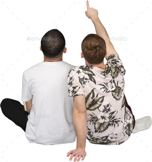 two men sitting next to each other while one of them is holding their ...