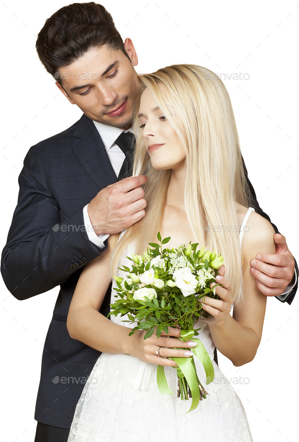 a bride and groom standing next to each other with a bouquet Stock ...
