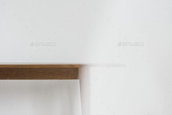 Wooden dining table against the wall with design space Stock Photo by ...
