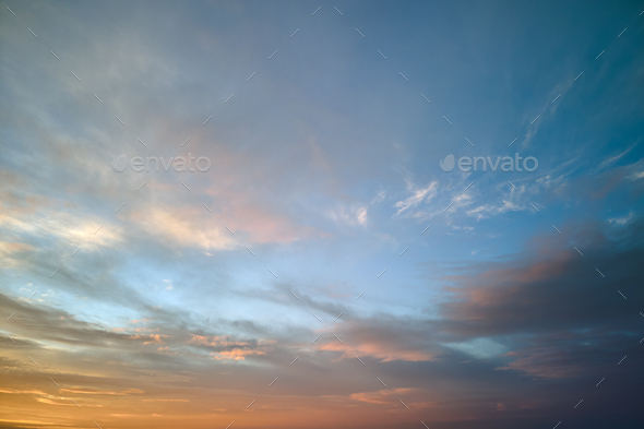 Bright colorful sunset sky with vivid smooth clouds illuminated with ...