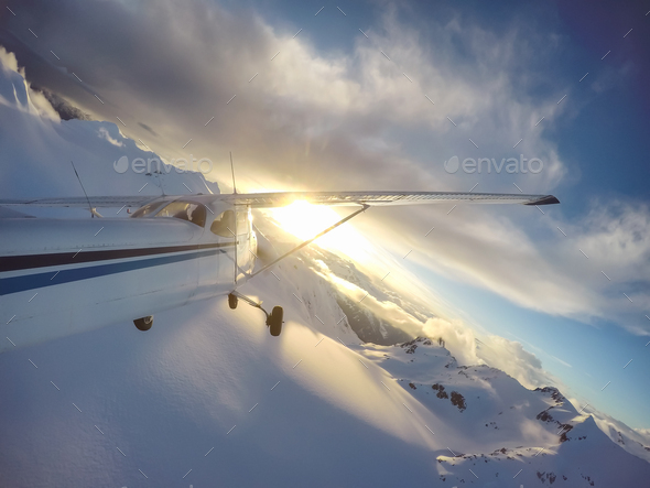 Small airplane flying over the Canadian Mountain Landscape Stock Photo ...