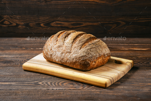Loaf of artisan sourdough bread with porous texture Stock Photo by boomeart