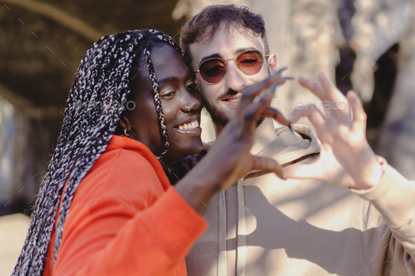 Biracial lovers making the heart shape Stock Photo by baffos | PhotoDune