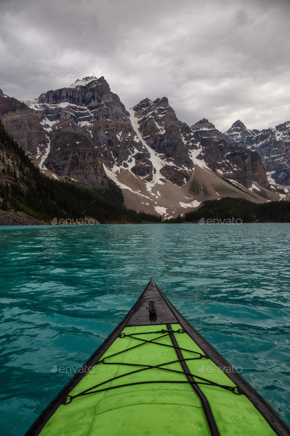 Kayaking in Glacier Water surounded by the Canadian Rocky Mountains ...