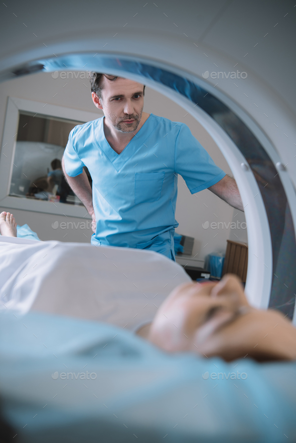 selective focus of concentrated radiologist operating ct scanner during ...