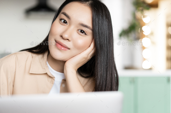Smiling asian girl sitting with laptop, working on computer pc Stock ...