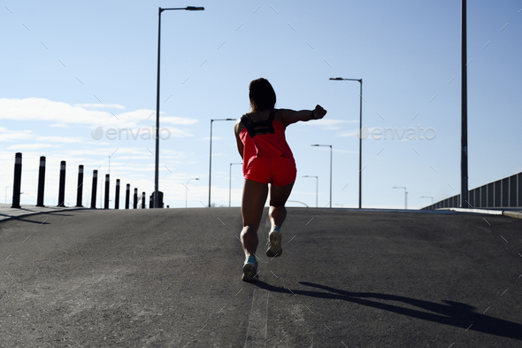 Runner woman running from behind Stock Photo by partidomiguelangel