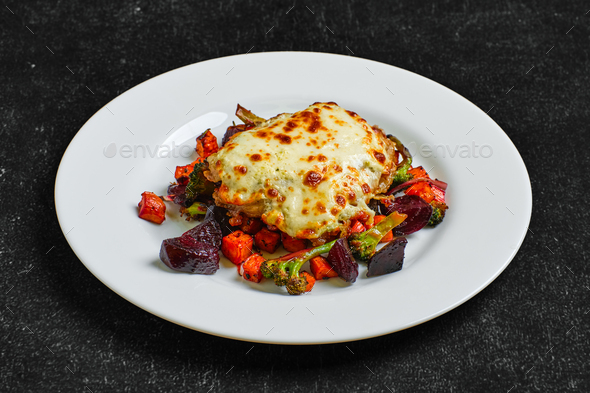 Cod fillet baked with cheese topping served with fried beet, carrot and ...