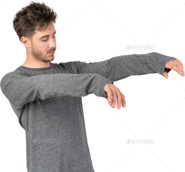 a young man holding his arm out in front of a black background Stock ...