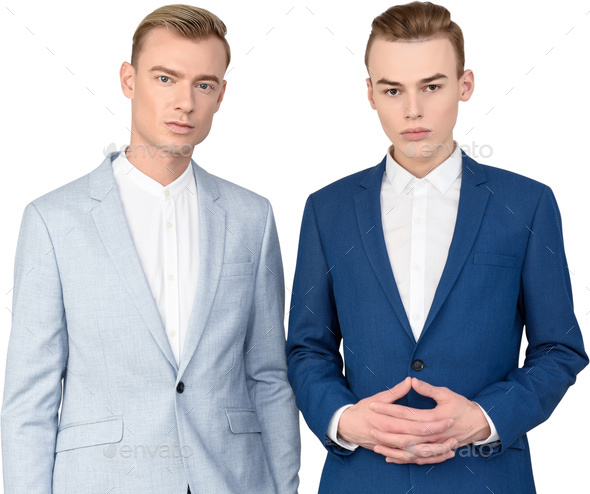 two men wearing suits and standing next to each other Stock Photo by Icons8