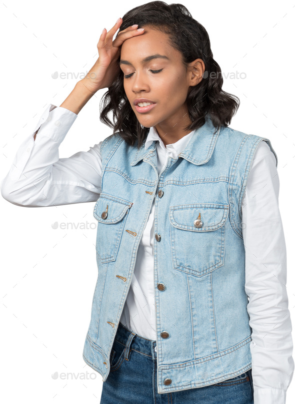 a woman in a denim jacket and denim jeans scratching her head Stock ...