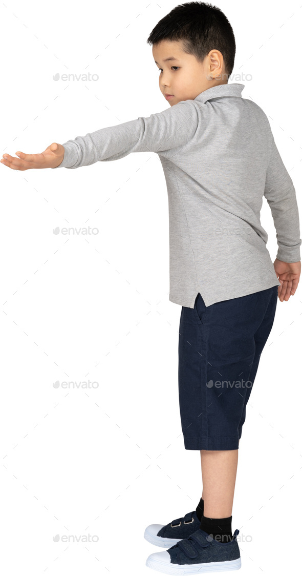 a young boy is standing with his arm outstretched and holding his hand ...