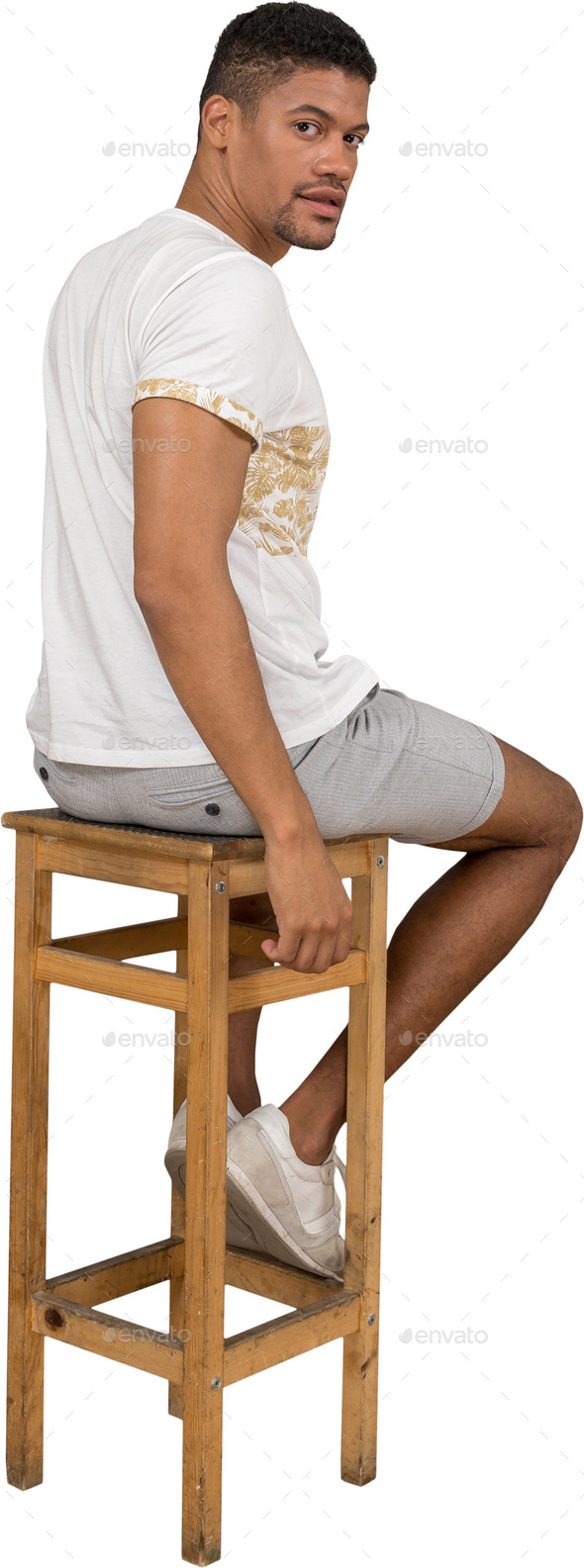 a man sitting on a stool with his foot on a chair Stock Photo by Icons8