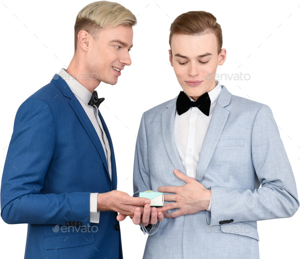 two men in suits looking at a ring on a woman Stock Photo by Icons8