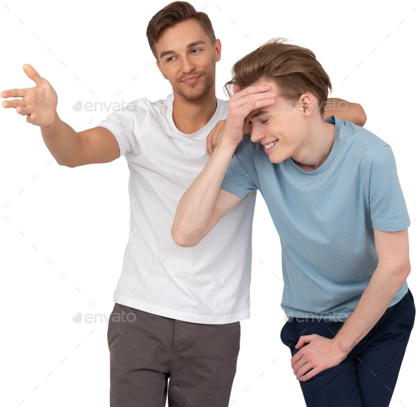 two young men standing next to each other with their hands on their ...