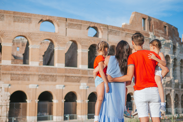 Happy family in Europe. Parents and kids in Rome over Coliseum ...