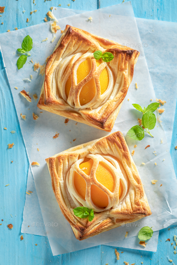 Awesome puff pastry stuffed with fresh peaches Stock Photo by Shaiith