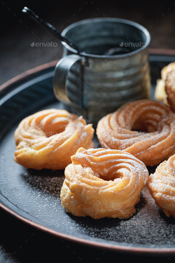 Enjoy your spanish donuts with powdered sugar Stock Photo by Shaiith