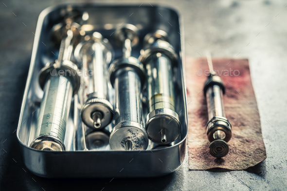 Syringes with a needle on metal table Stock Photo by Shaiith | PhotoDune