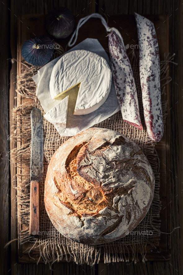 Load of bread with camembert cheese, sausage and fig Stock Photo by Shaiith