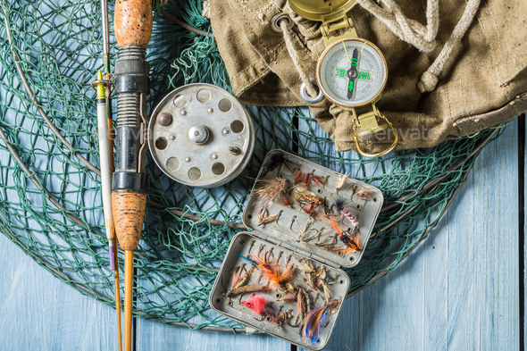 Angler equipmen with compass, rods and backpack Stock Photo by Shaiith