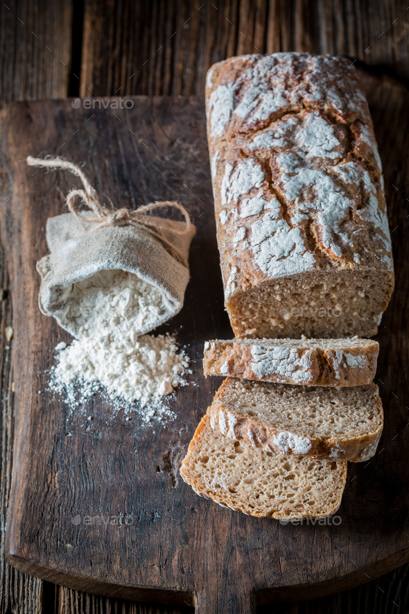 Top view of loaf of bread with whole grains Stock Photo by Shaiith