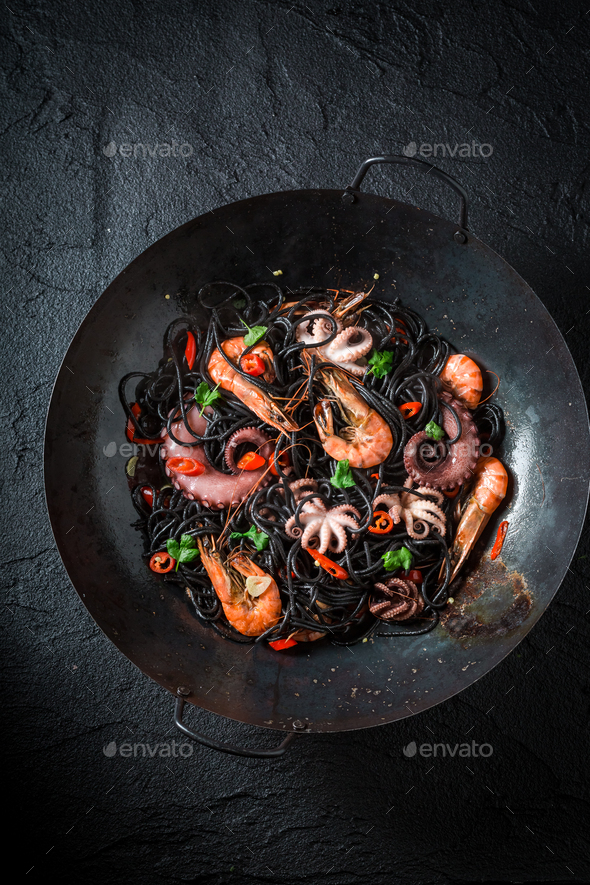 Cooking spaghetti with seafood made of tiger prawns and octopus Stock ...