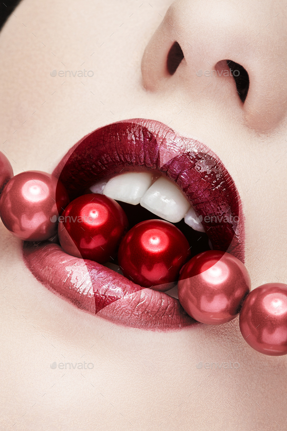 Heart shape lips with pearls through mouth Stock Photo by DC_Studio