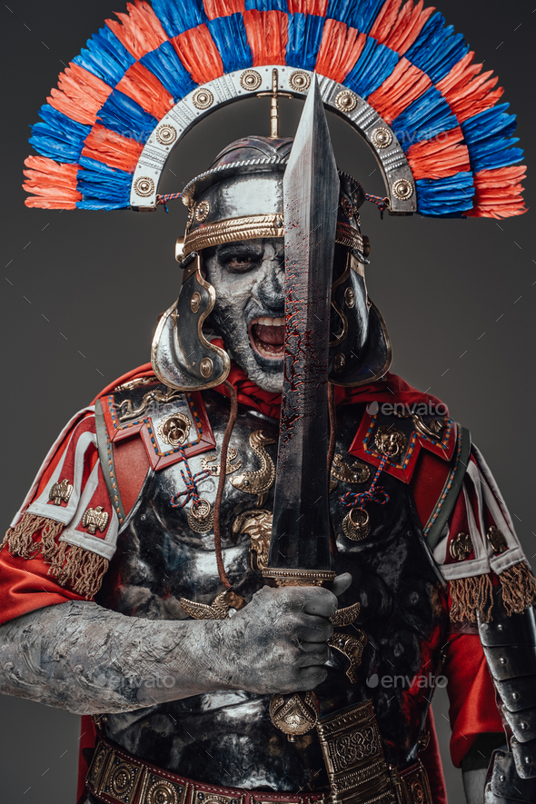 Screaming evil zombie centurion with sword isolated on gray Stock Photo ...