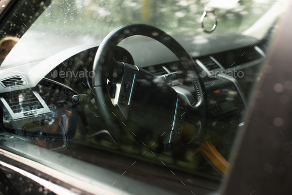 Car interior, dashboard view through window outside. Selective focus on ...